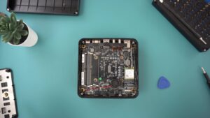 To remove the SSD, first, unscrew the screw at the top holding the ...